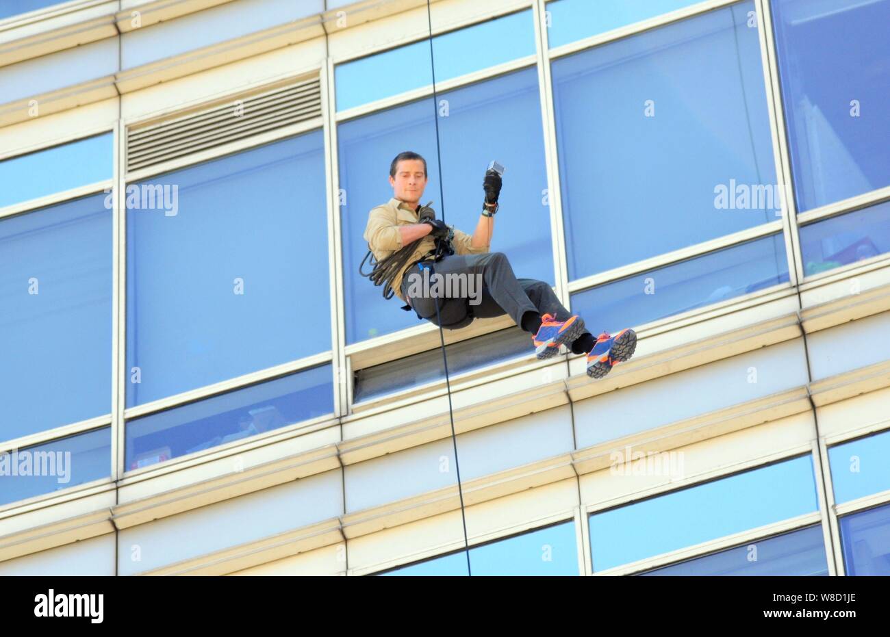 British adventurer and television presenter Bear Grylls abseils from a ...