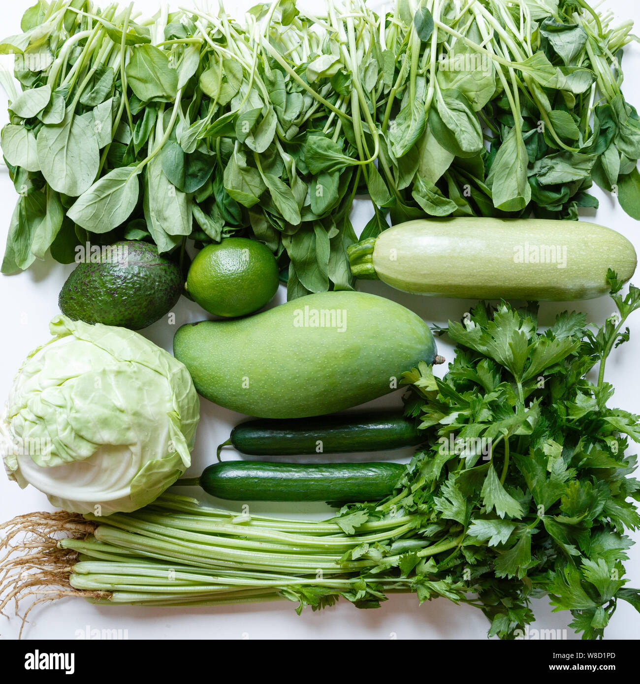 Fresh green vegetables variety on rustic white background from overhead ...