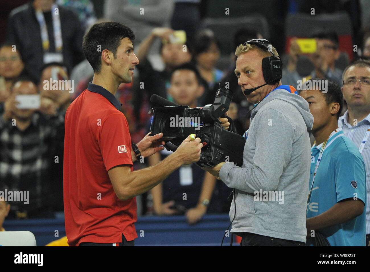 Novak Djokovic of Serbia, left, writes the Chinese character "Xiao ...