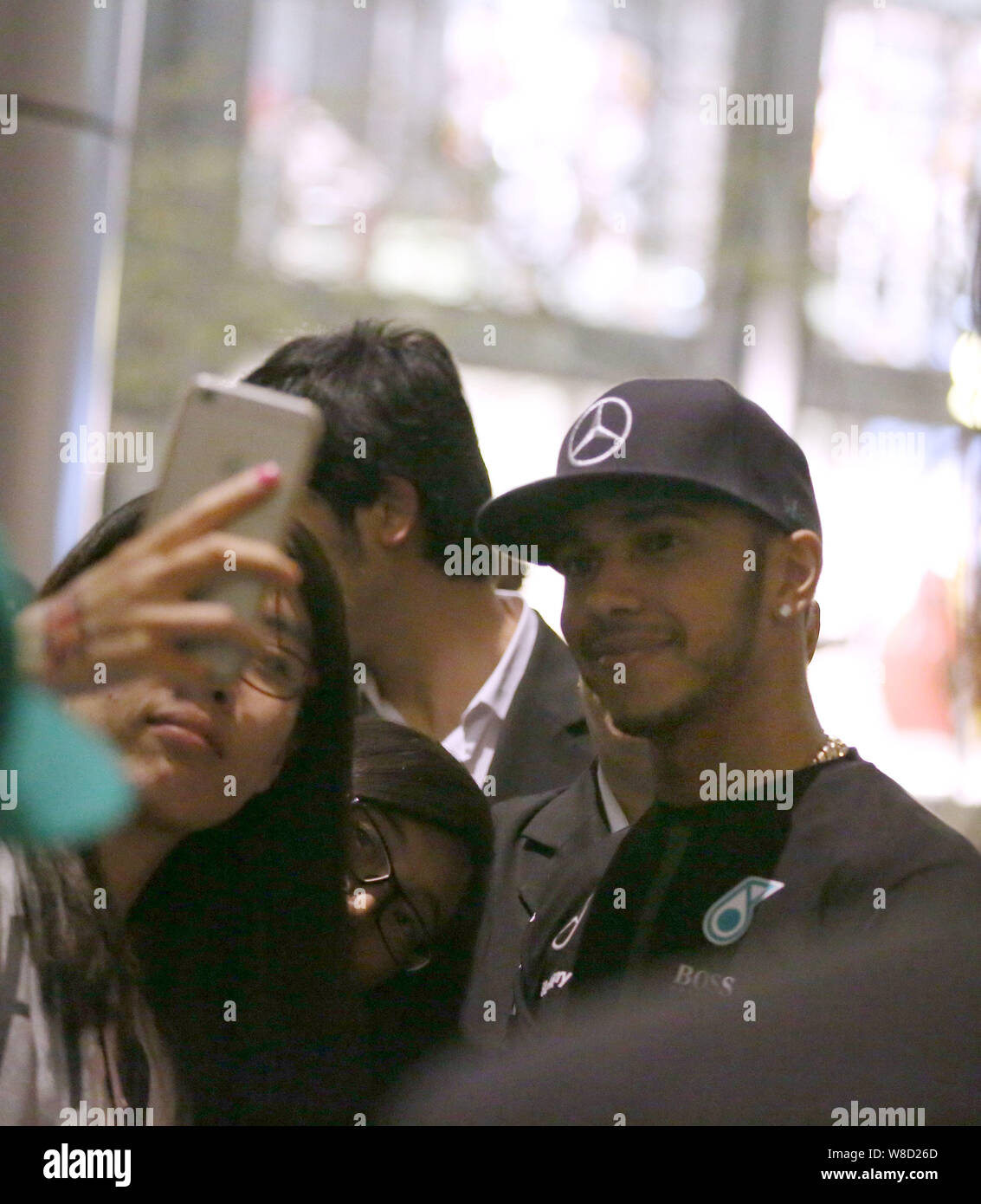 British F1 driver Lewis Hamilton of Mercedes poses with a fan for a ...