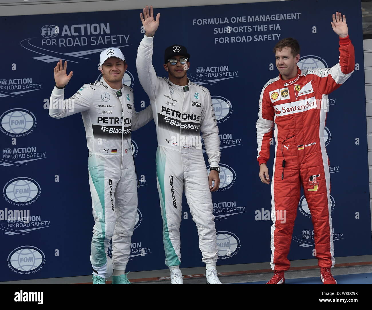 British F1 driver Lewis Hamilton of Mercedes AMG, center, waves between ...
