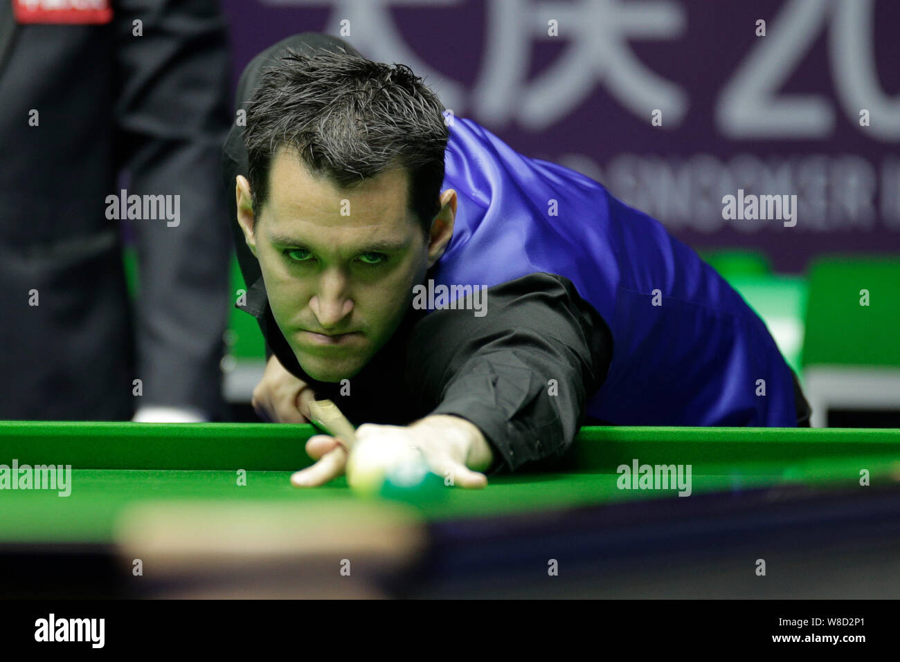 Tom Ford of England plays a shot to Judd Trump of England in their ...