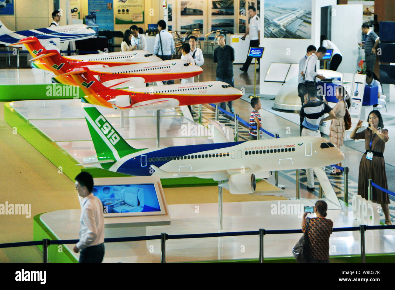 --FILE--Visitors look at models of C919 and ARJ21 jet planes at the ...