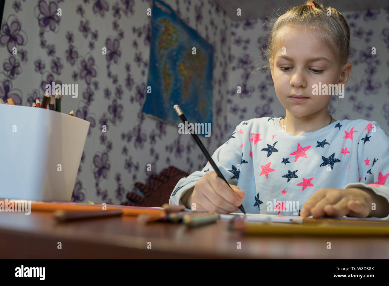 The child draws a picture with colored pencils Stock Photo - Alamy