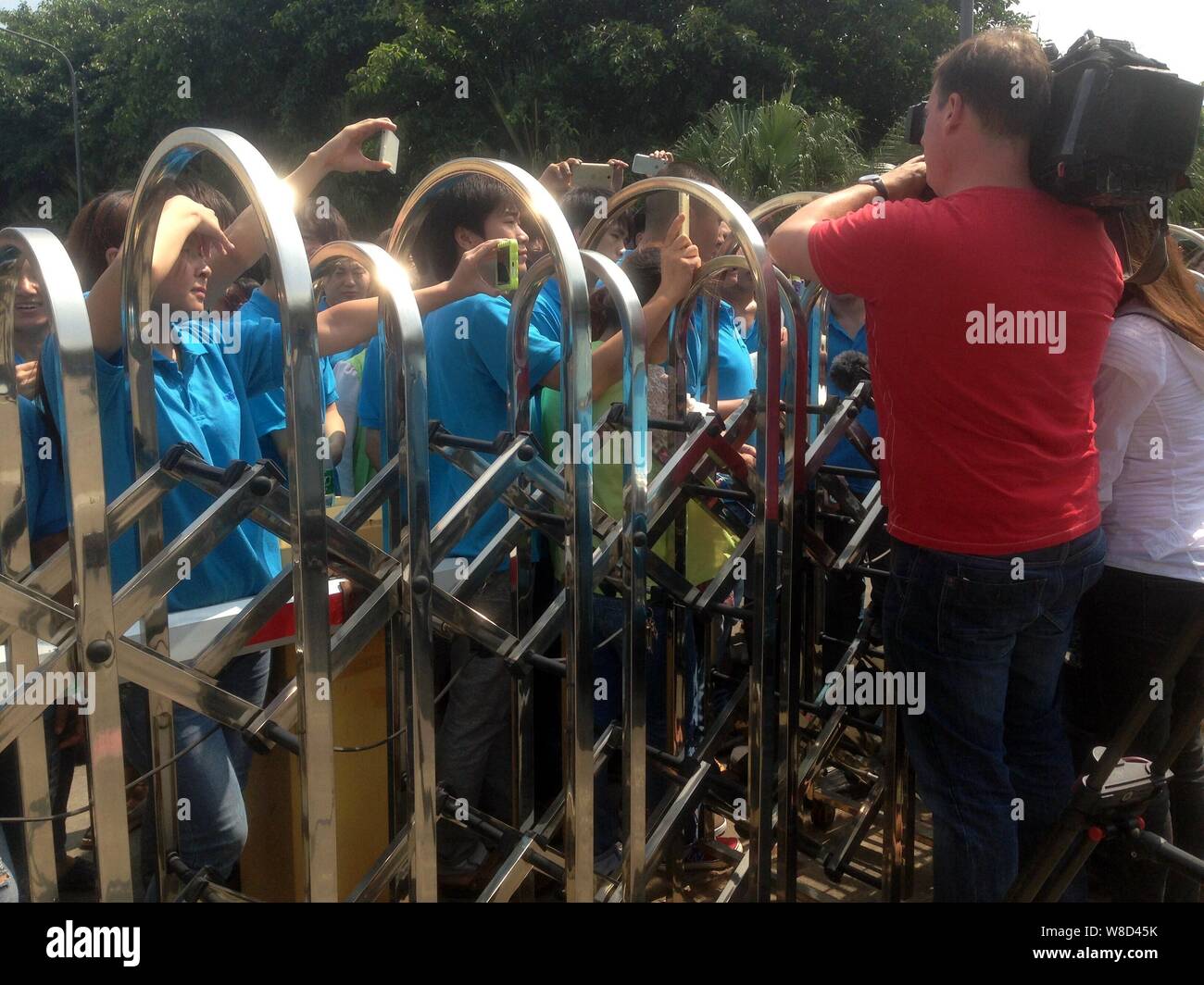 Chinese workers crowd at the entrance of the factory of Kinpo ...