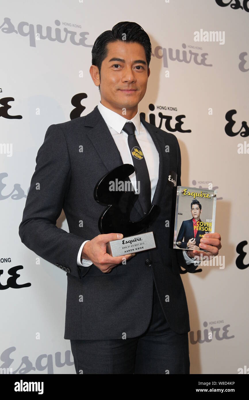 Hong Kong singer and actor Aaron Kwok poses with his trophies for the ...