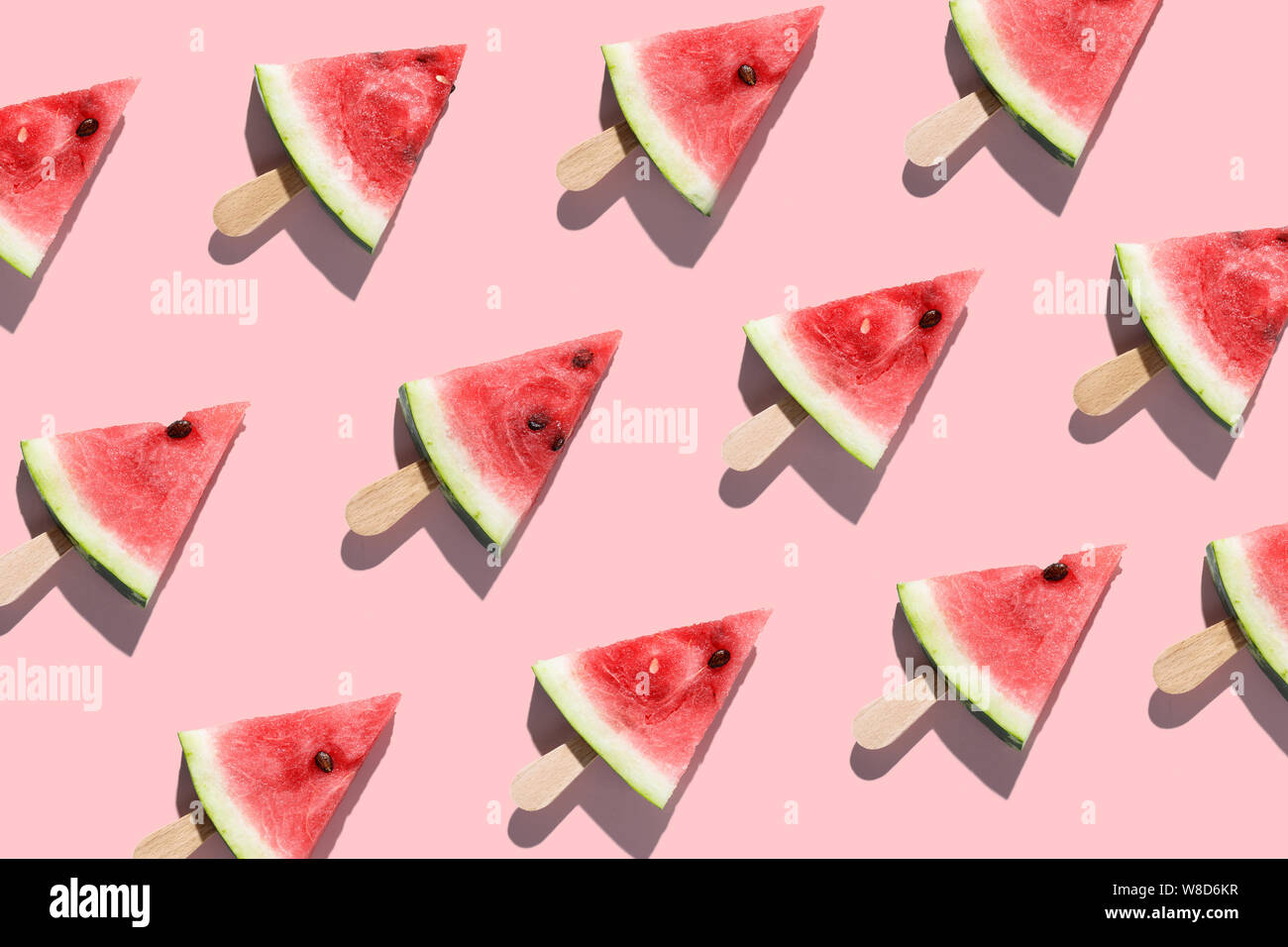 Sliced watermelons arranged on a pink background Stock Photo - Alamy
