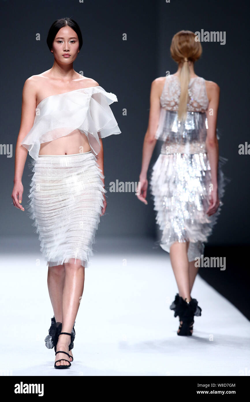 A model displays a new creation at the fashion show of Chinese wedding ...