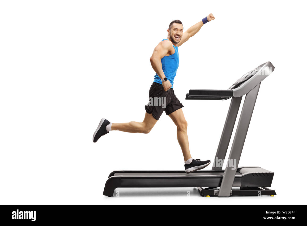 Full length shot of a young muscular man running on a treadmill and ...