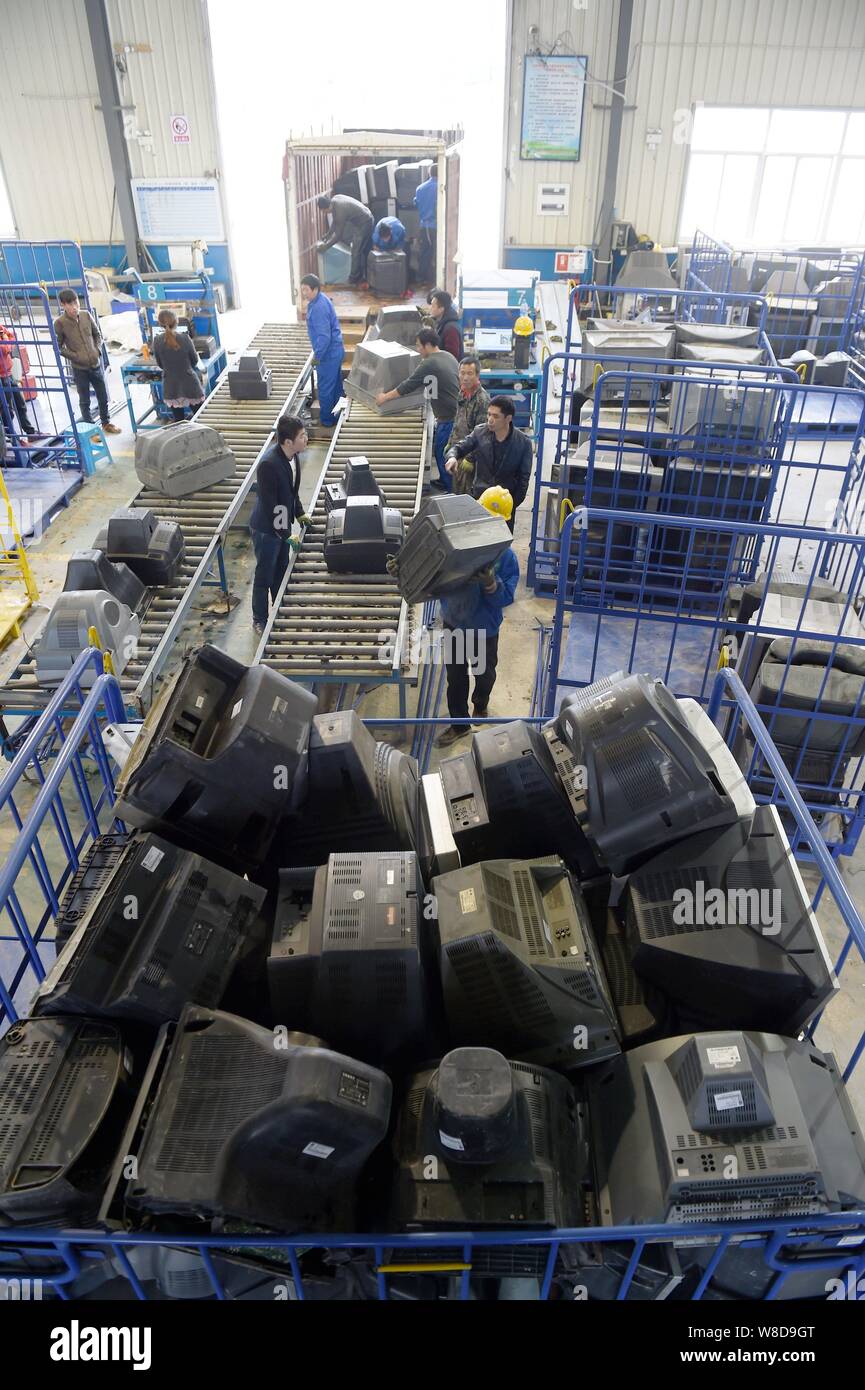 Chinese workers pile up discarded CRT TV sets to be disassembled and ...