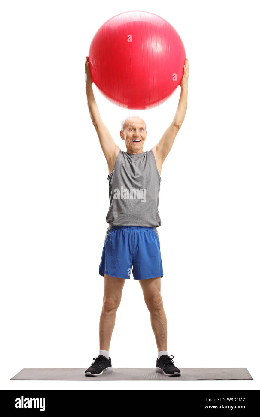 Full length portrait of an elderly man lifting a fitness ball isolated ...