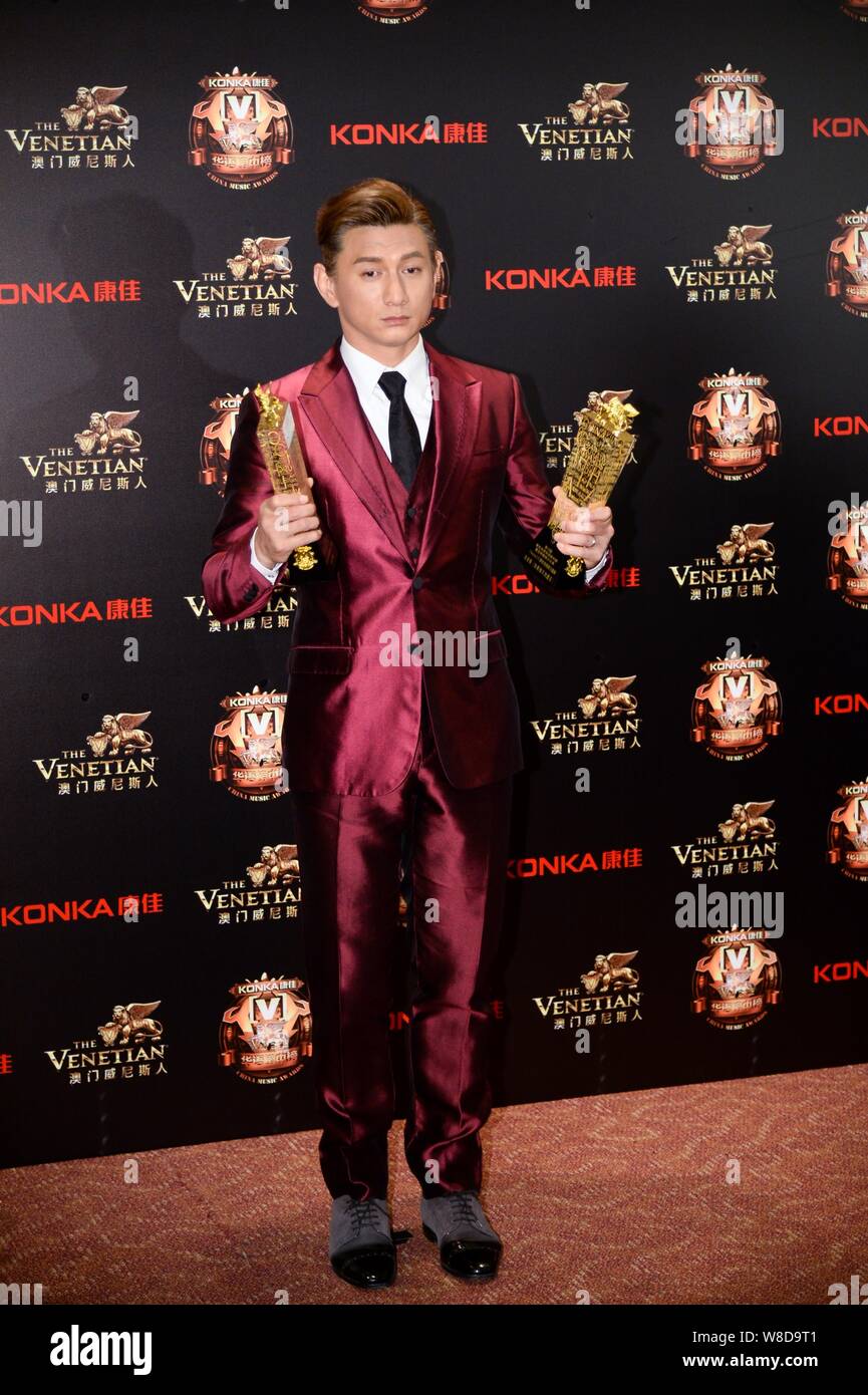 Taiwanese singer and actor Nicky Wu poses with his trophies after the ...