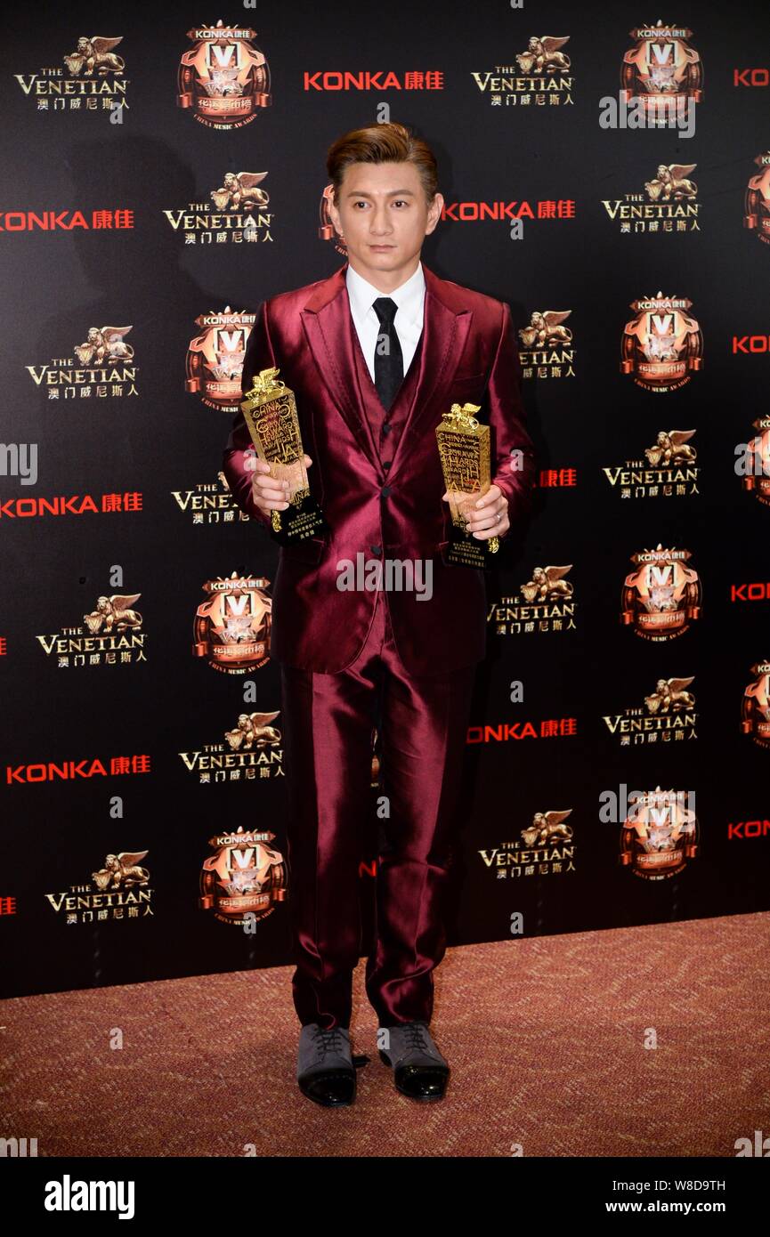 Taiwanese singer and actor Nicky Wu poses with his trophies after the ...