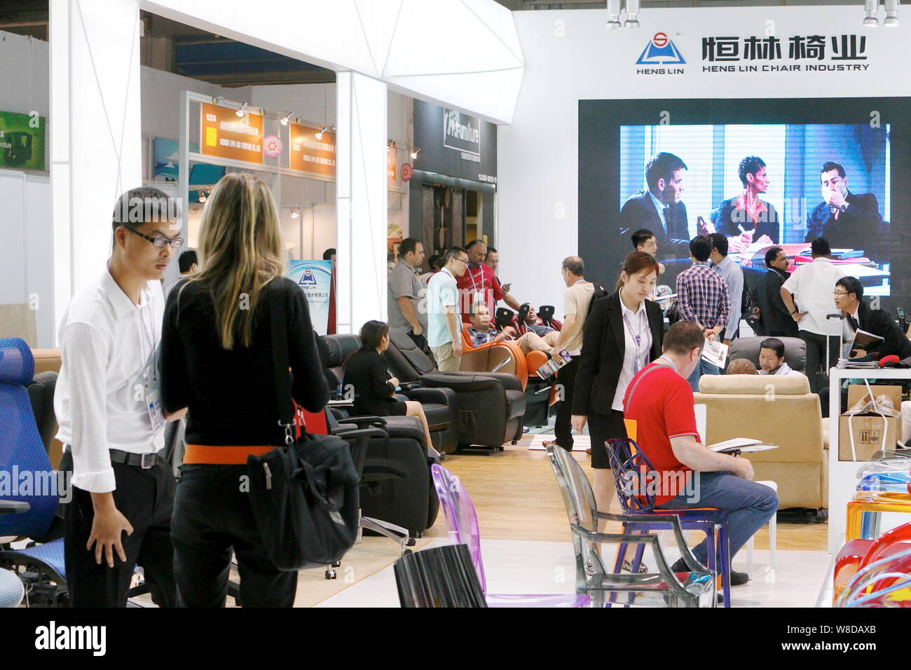 --FILE--Buyers talk with employees of Henglin Chair Industry during the ...