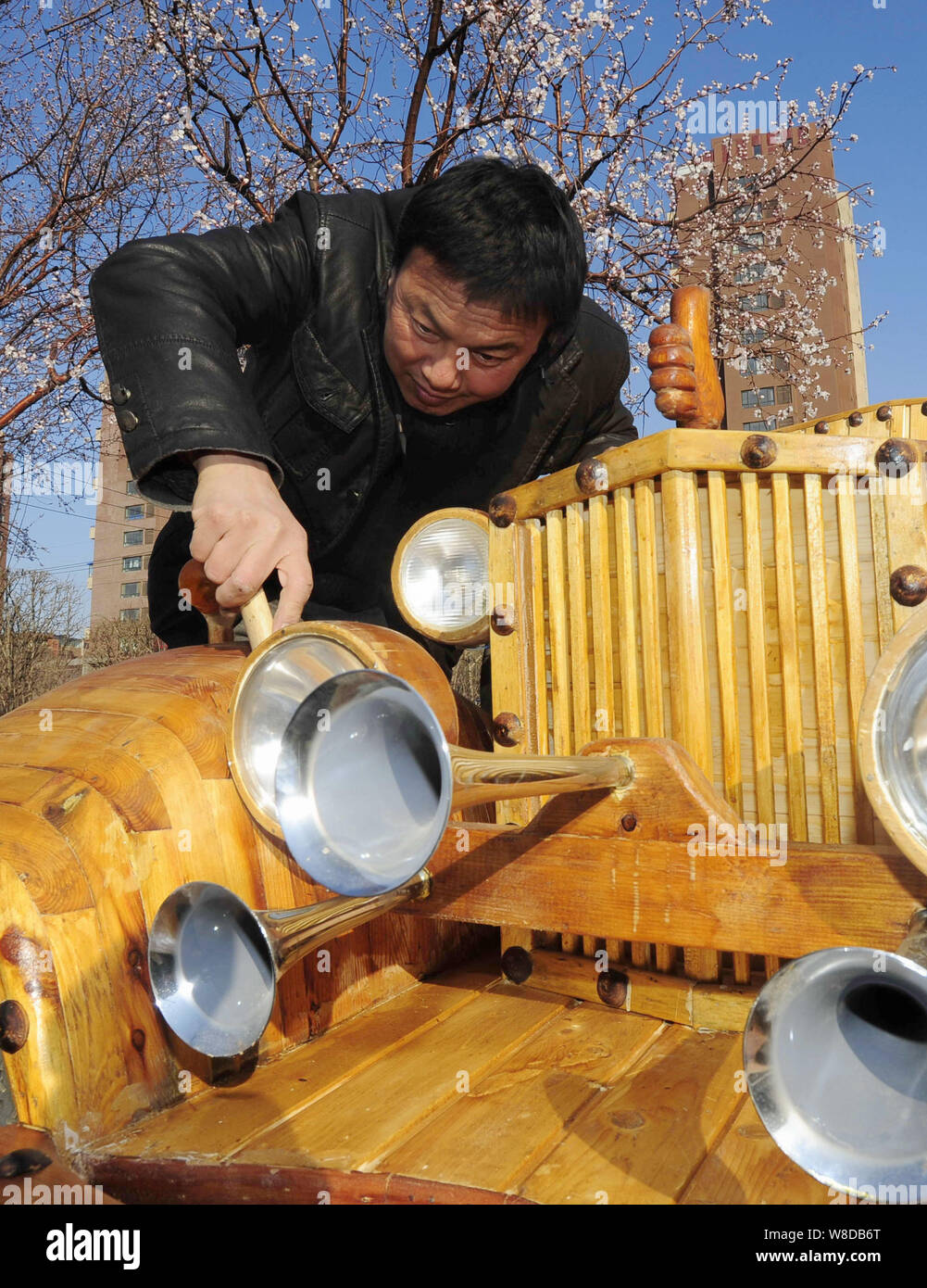 Chinese carpenter Liu Fulong checks his third homemade wooden electric ...
