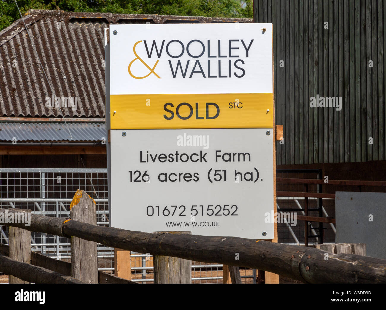 Estate agent Woolley and Wallis property sold sign at livestock farm ...