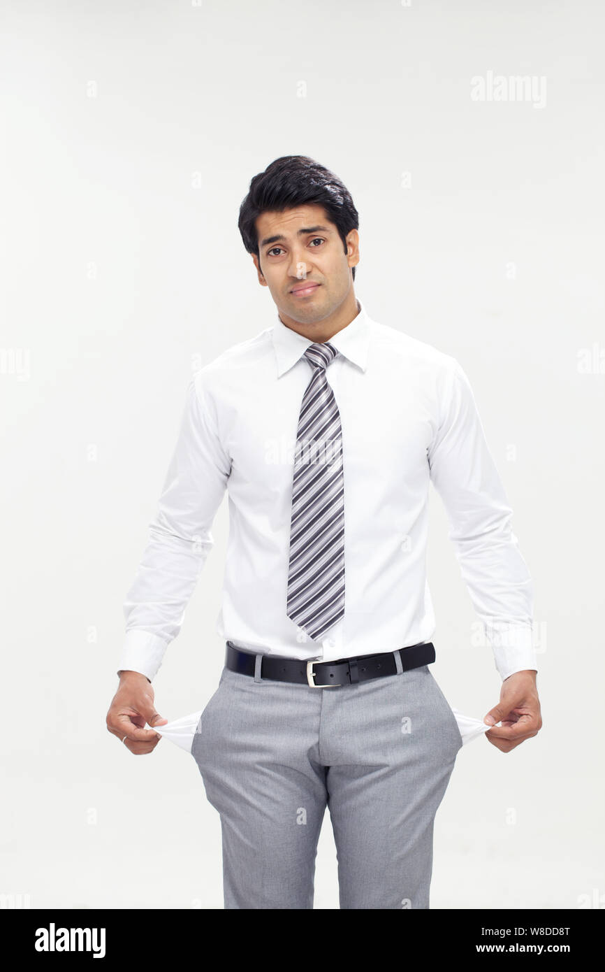 Businessman showing out his empty pockets Stock Photo - Alamy