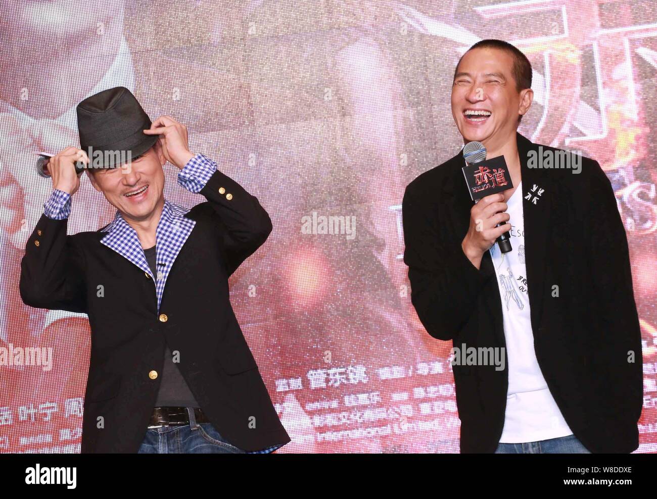 Hong Kong singers and actors Jacky Cheung, left, and Nick Cheung react ...