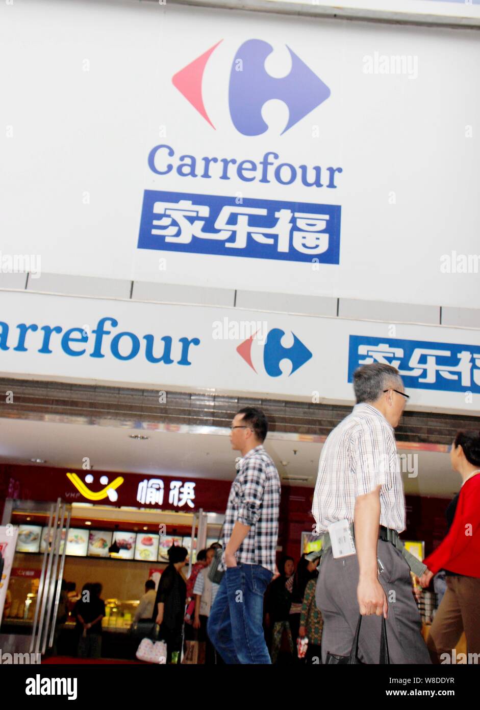 --FILE--Pedestrians walk past a Carrefour supermarket in Chongqing ... --FILE--Pedestrians walk past a Carrefour supermarket in Chongqing ...