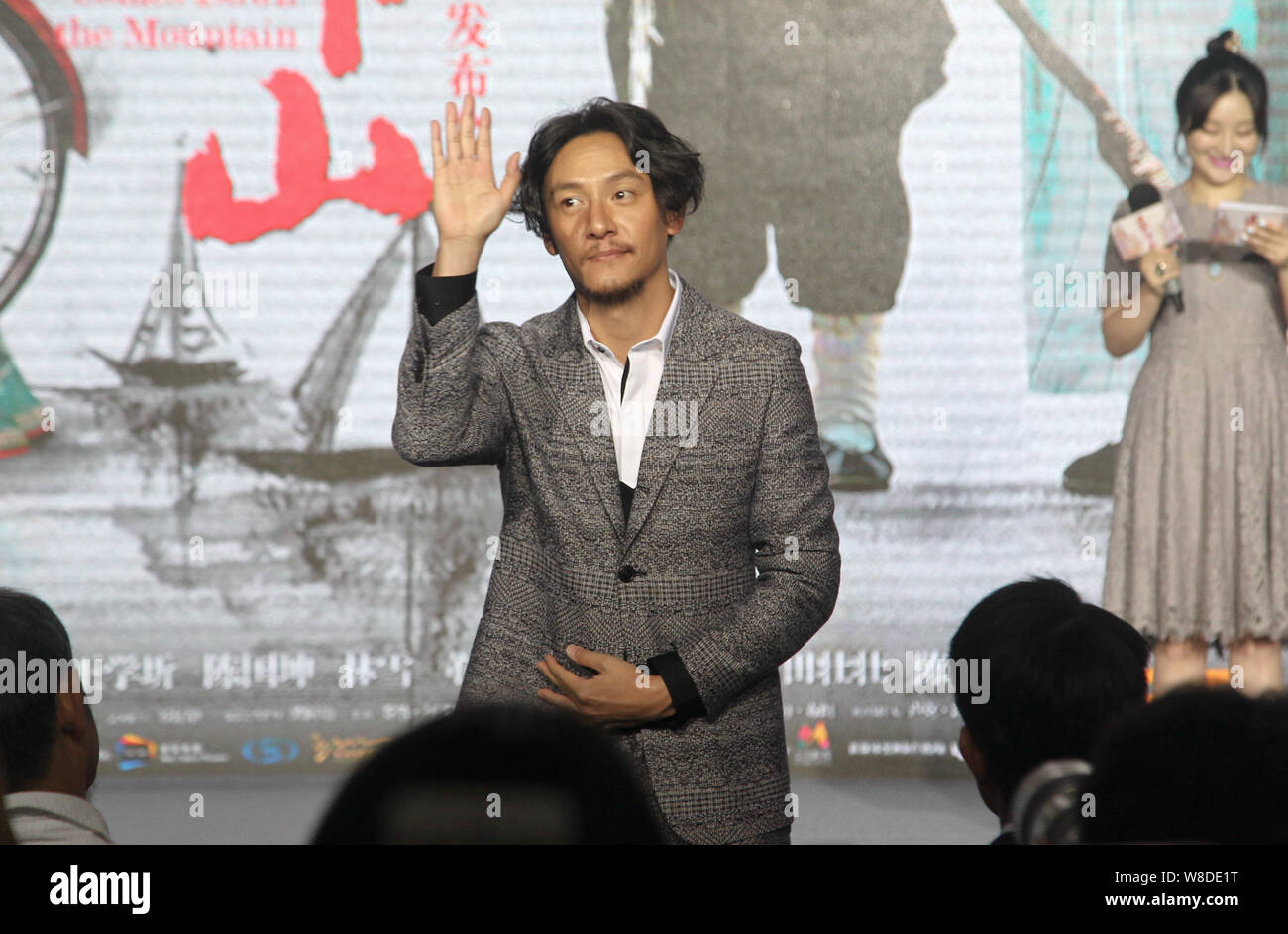 Taiwanese actor Chang Chen waves at a press conference for his movie "Monk Comes Down The ...