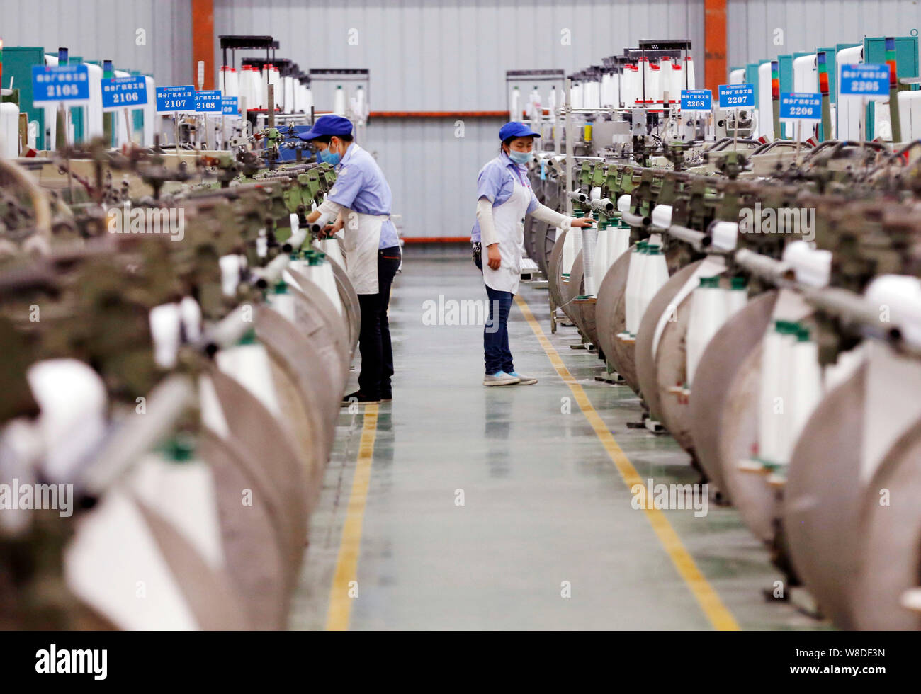 --FILE--Female Chinese workers monitor production of fibreglass at a ...