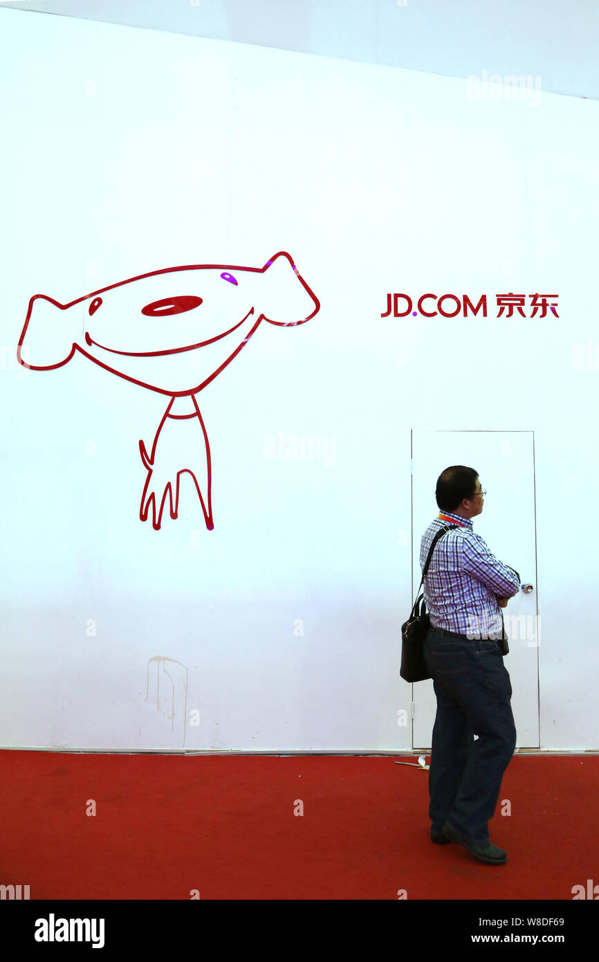 --FILE--A visitor stands in front of a signboard of Chinese online ...