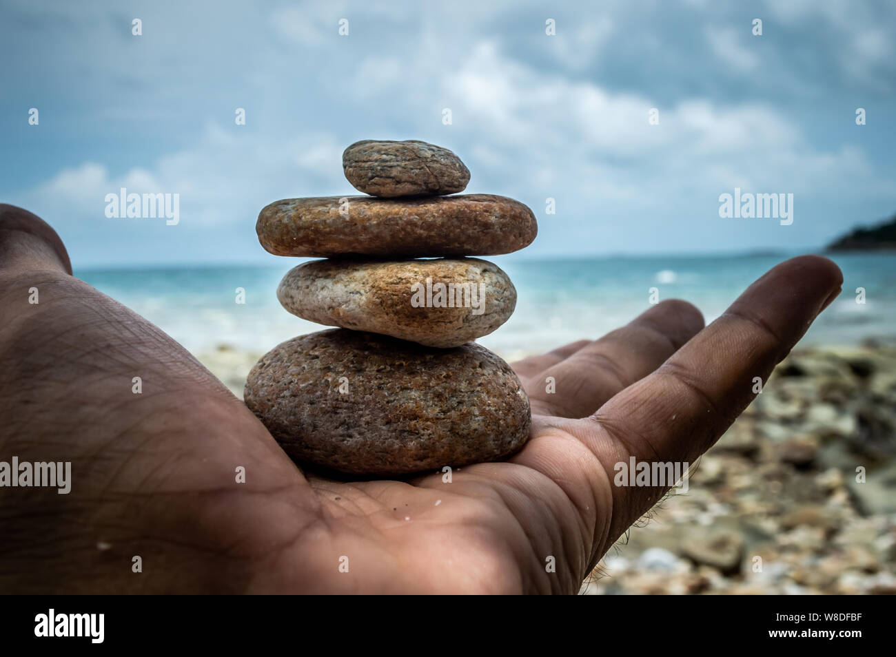 Rock on hand at the beach Koh Samet Stock Photo - Alamy