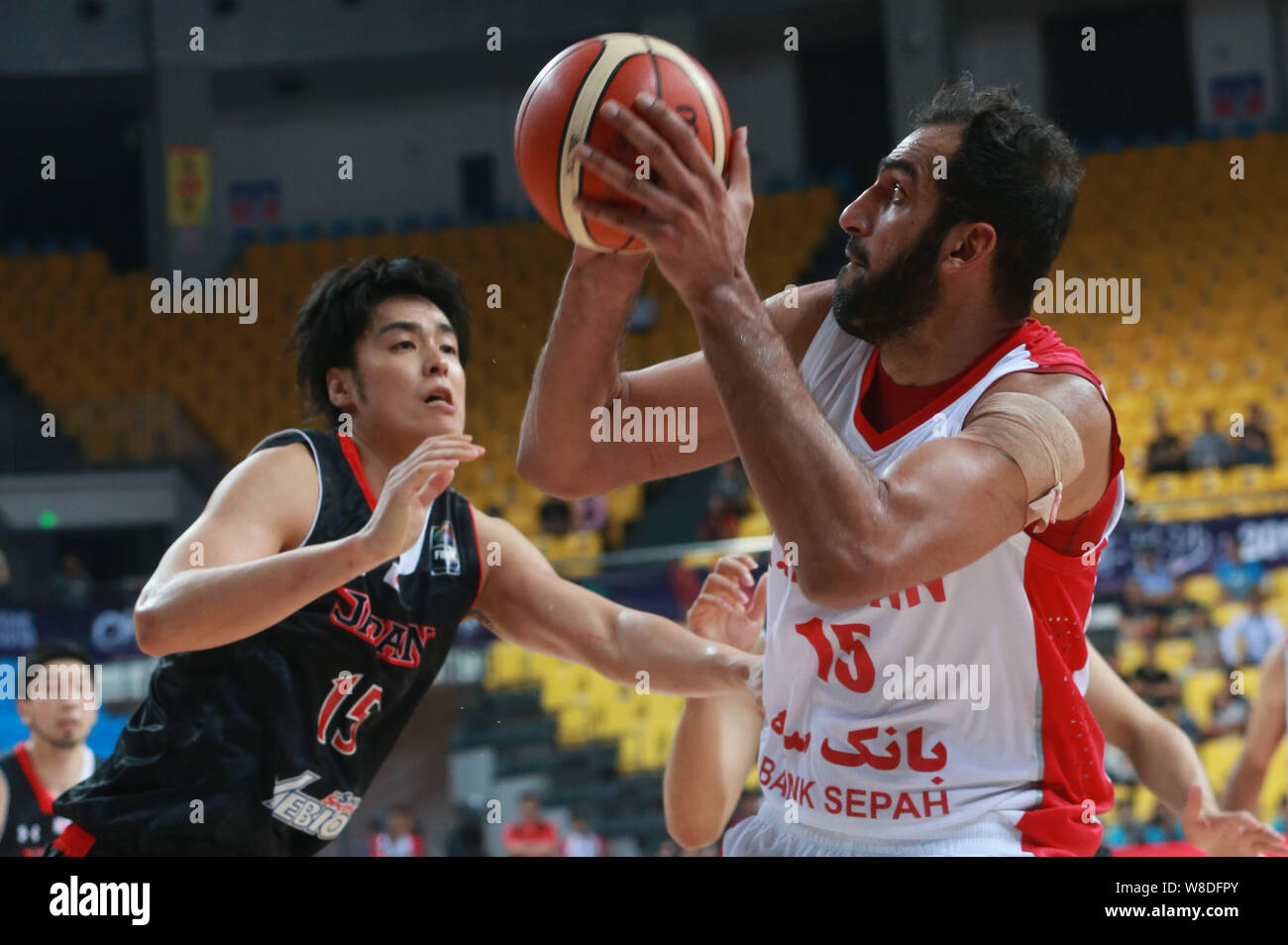 Joji Takeuchi of Japan, right, challenges Hamed Ehadadi of Iran in the ...