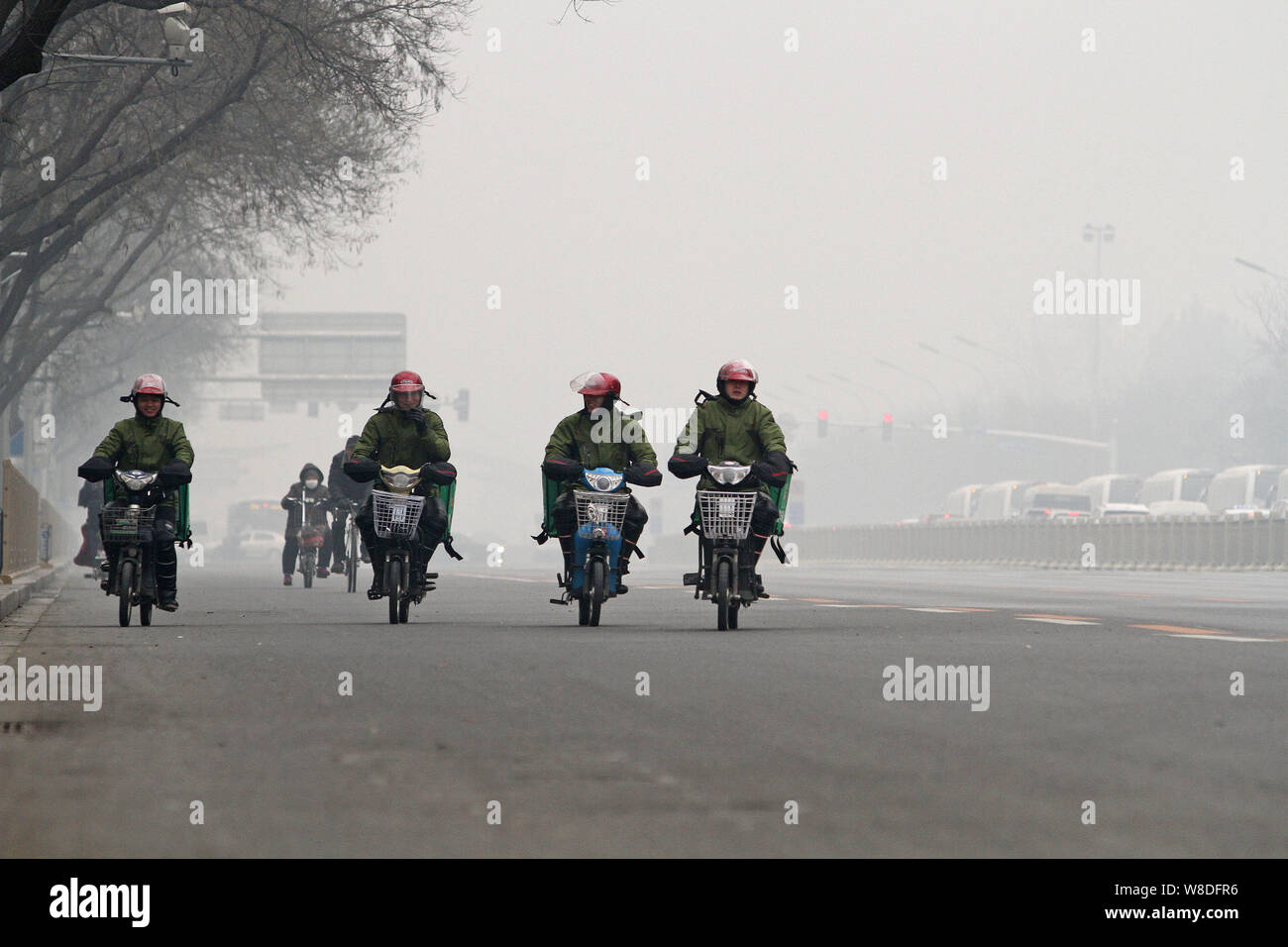 Cyclists ride on a road in heavy smog in Beijing, China, 28 November ...