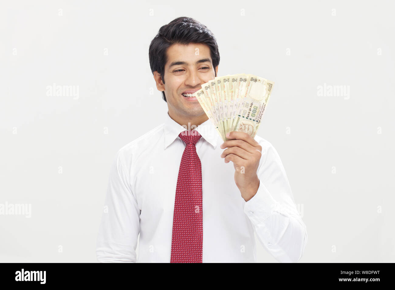 Businessman holding one hundred rupees banknotes Stock Photo - Alamy