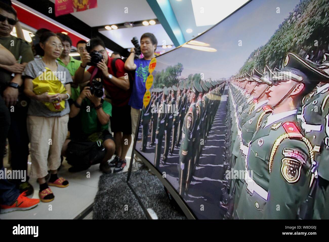 Local Chinese residents watch the live TV broadcast of the military ...