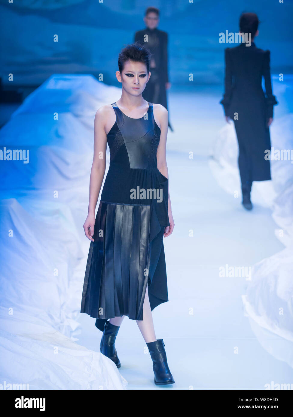 A model displays a new creation designed by Liu Shixi at the "The ...