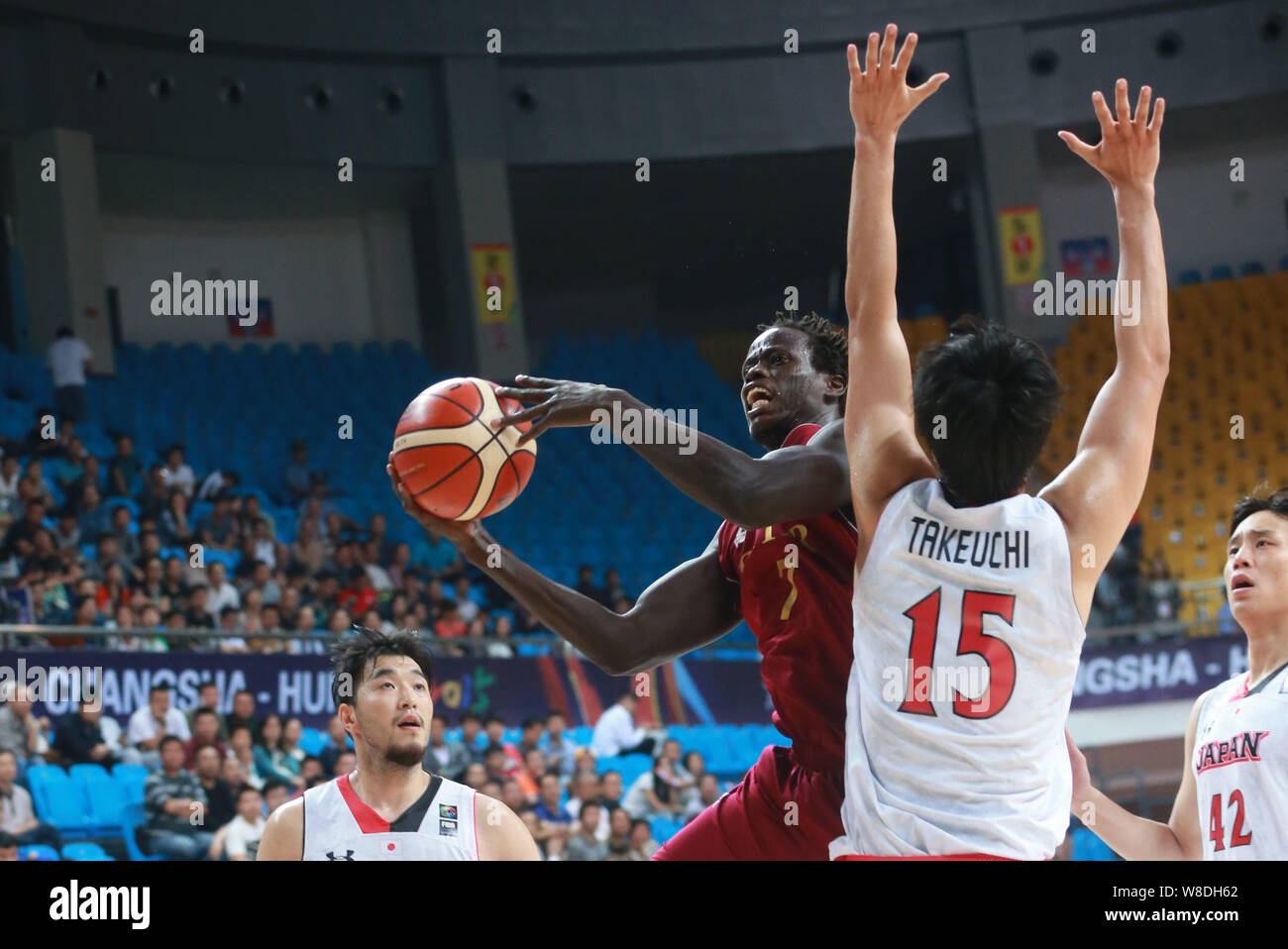 Joji Takeuchi of Japan, front, challenges Daoud Mousa Daoud of Qatar in ...