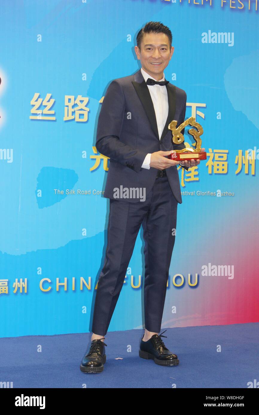 Hong Kong actor Andy Lau holds his trophy for the Best Actor award ...