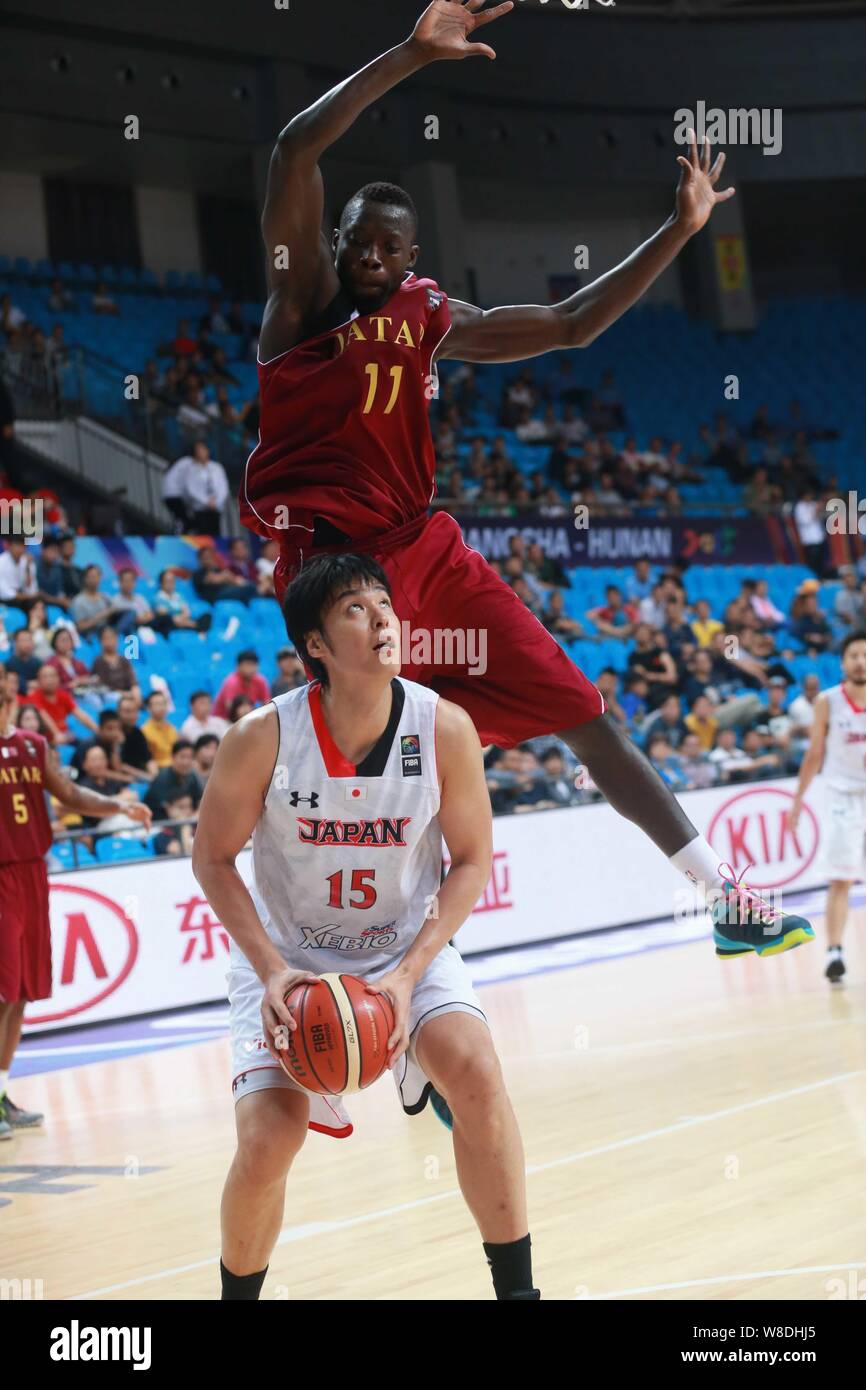 Joji Takeuchi of Japan, front, prepares to shoot against Ali Saeed ...