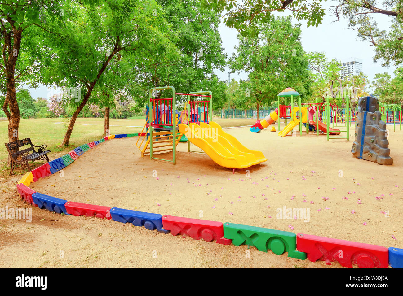 Colorful children playground activities in public park surrounded by ...