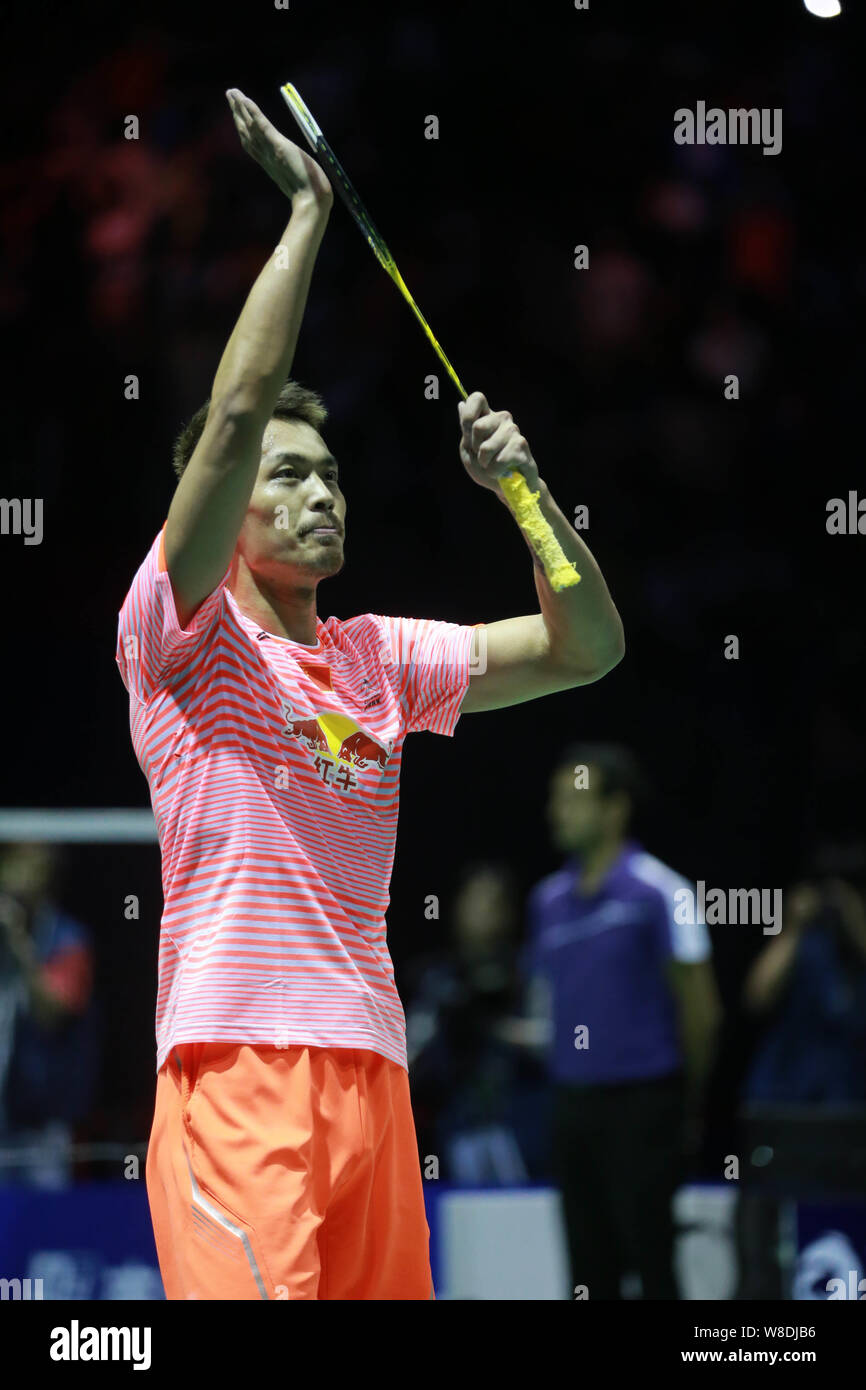 Lin Dan of China celebrates after defeating Takuma Ueda of Japan in ...