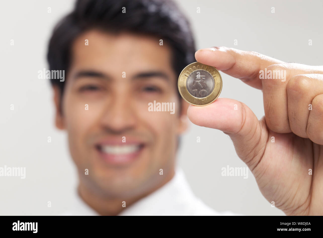Man showing a coin Stock Photo - Alamy