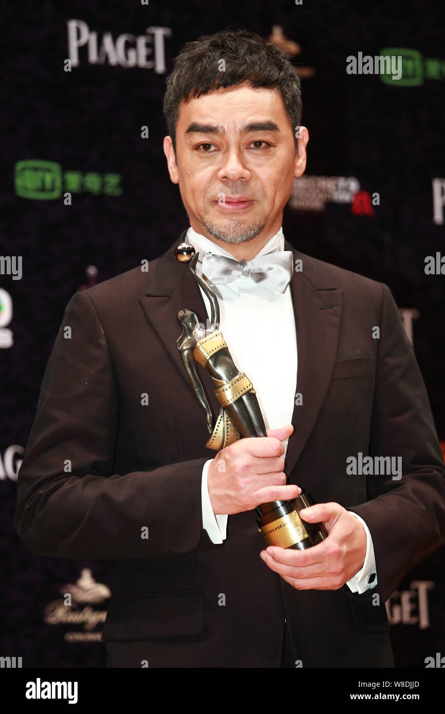 Hong Kong actor Sean Lau poses with the trophy for the Best Actor award ...