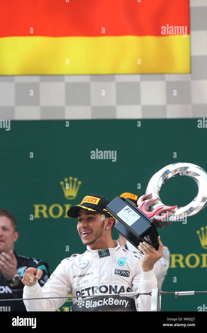 Britain's Lewis Hamilton of Mercedes celebrates with his champion ...