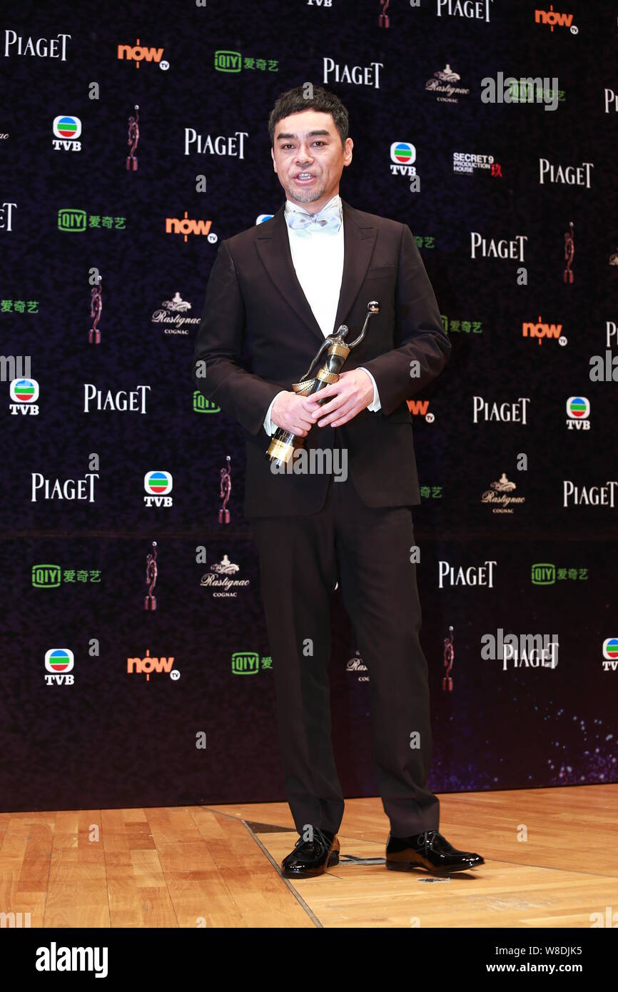 Hong Kong actor Sean Lau poses with the trophy for the Best Actor award ...