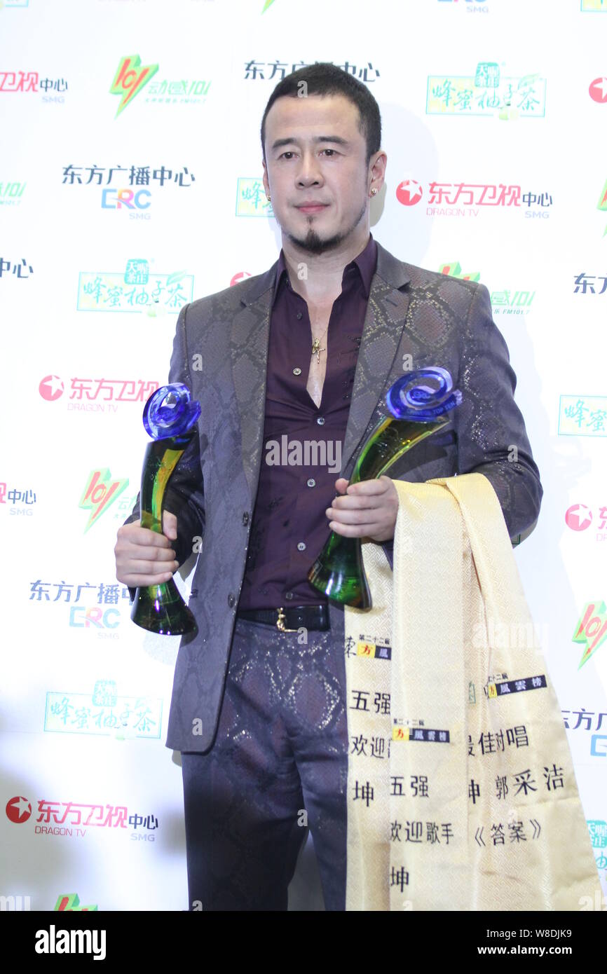 Chinese singer Yang Kun poses with his trophies during the 22th ...