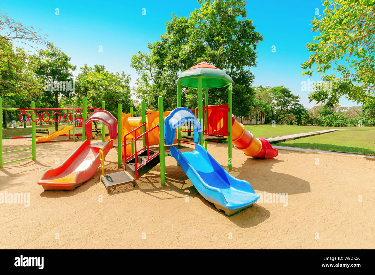 Colorful children playground activities in public park surrounded by ...