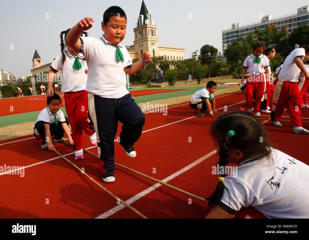 --FILE--Young Chinese students do physical exercises during a citywide ...
