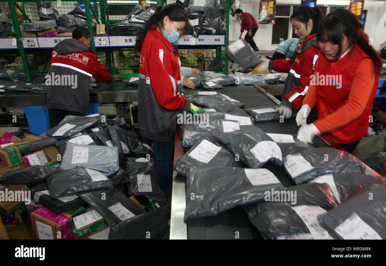 Chinese workers sort parcels, most of which are from online shopping ...