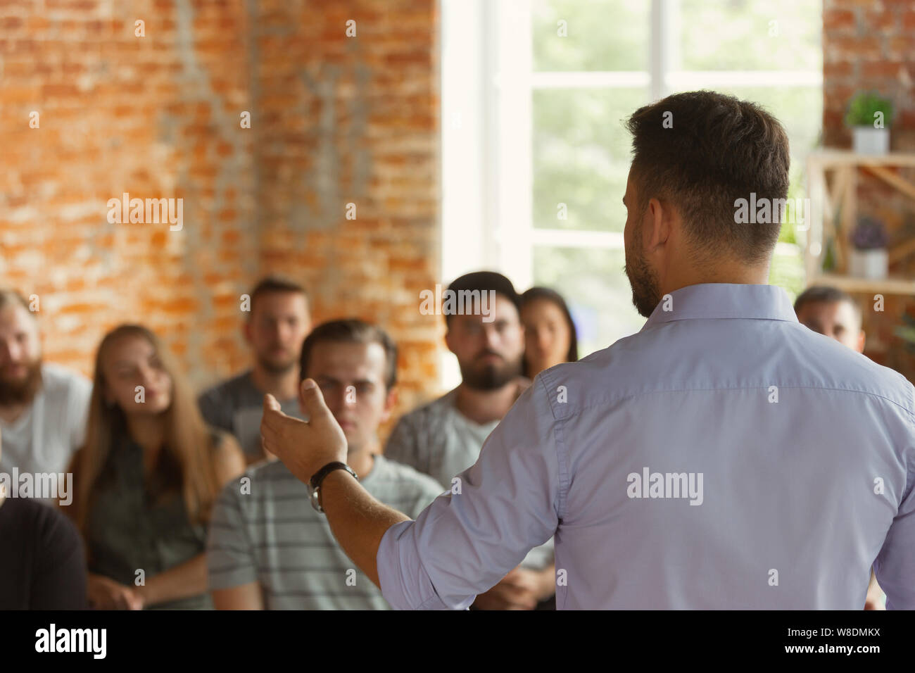 Male speaker giving presentation in hall at university workshop ...