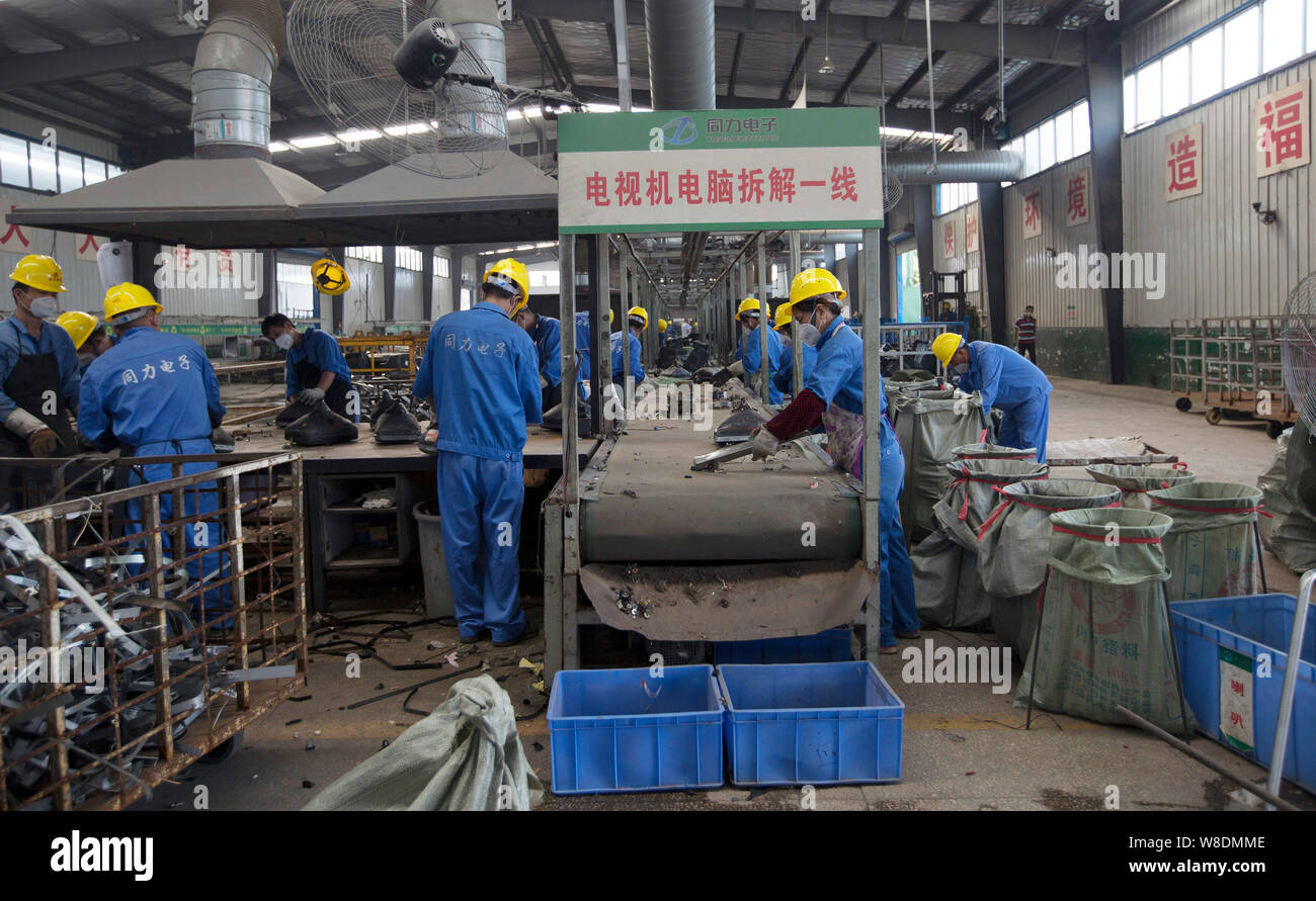 Chinese workers disassemble tube television sets in a plant at the ...