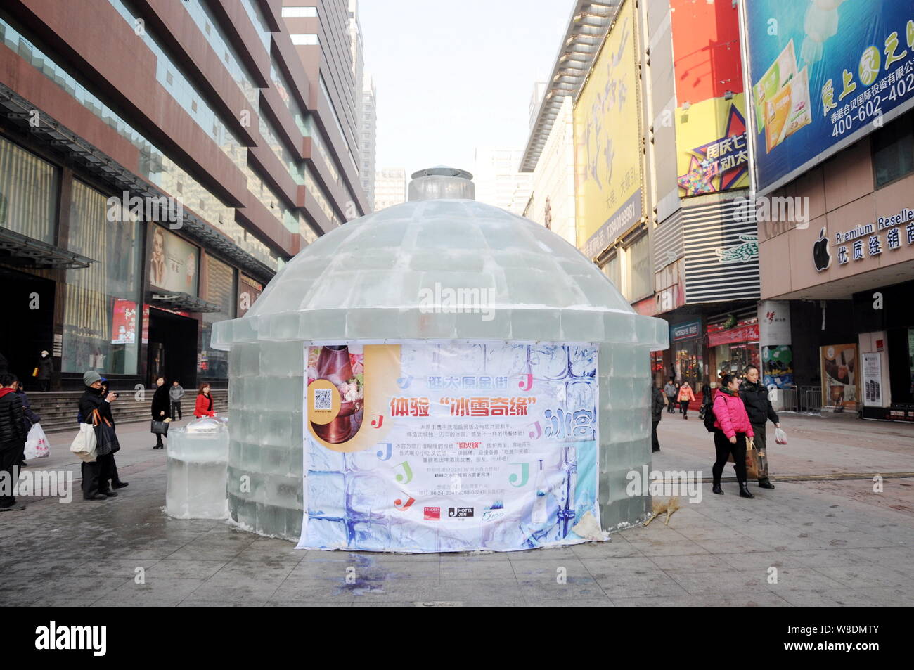 Pedestrians walk past the hotpot restaurant made of ice blocks on the ...
