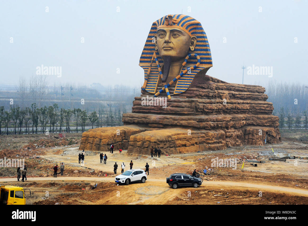Visitors walk past the replica of the Great Sphinx at the construction ...
