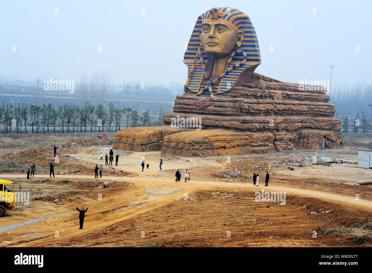 Visitors walk past the replica of the Great Sphinx at the construction ...